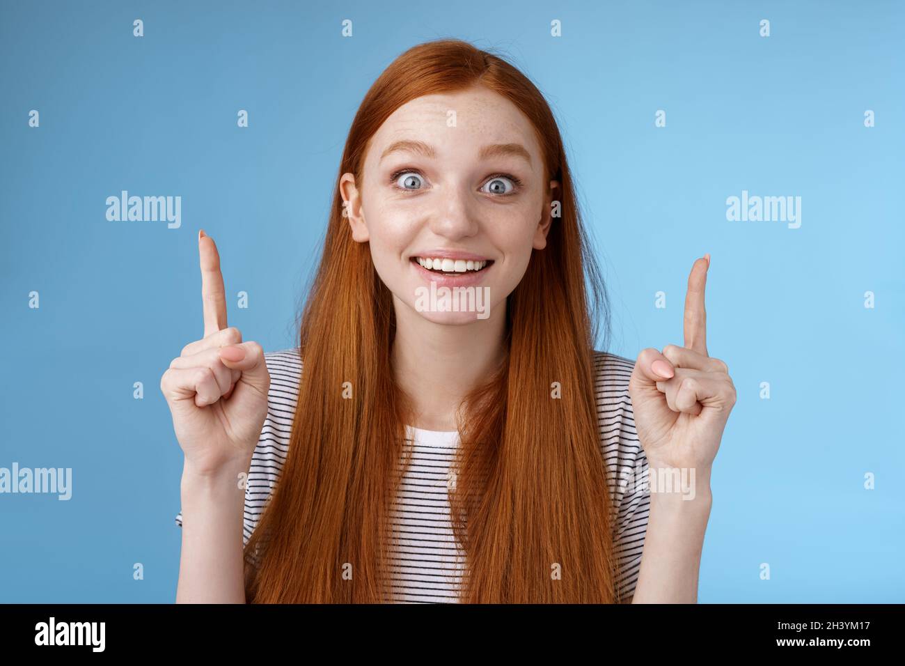 Thrilled happy young rejoicing redhead girl get awesome chance look ...