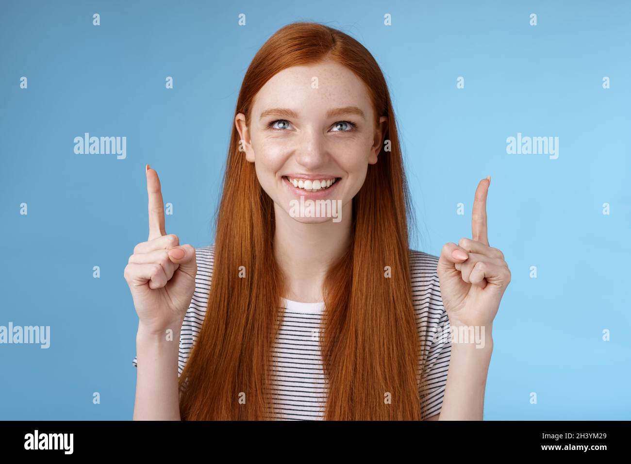 Amused Excited Happy Smiling Redhead Girl Look Pointing Up Grinning