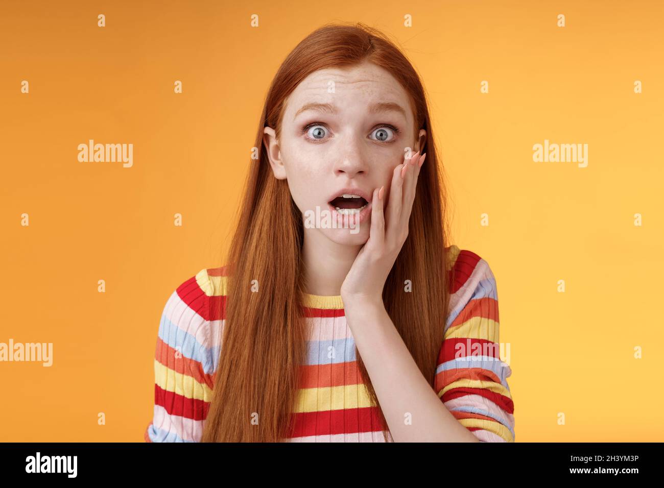 Concerned worried ginger girl blue eyes drop jaw gasping touch cheek ...