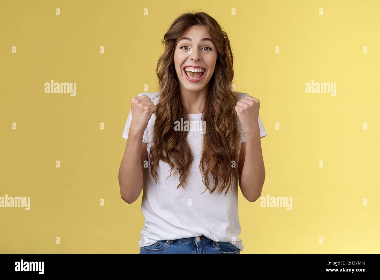 Yes finally success. Cheerful enthusiastic happy girl pump fists lift ...