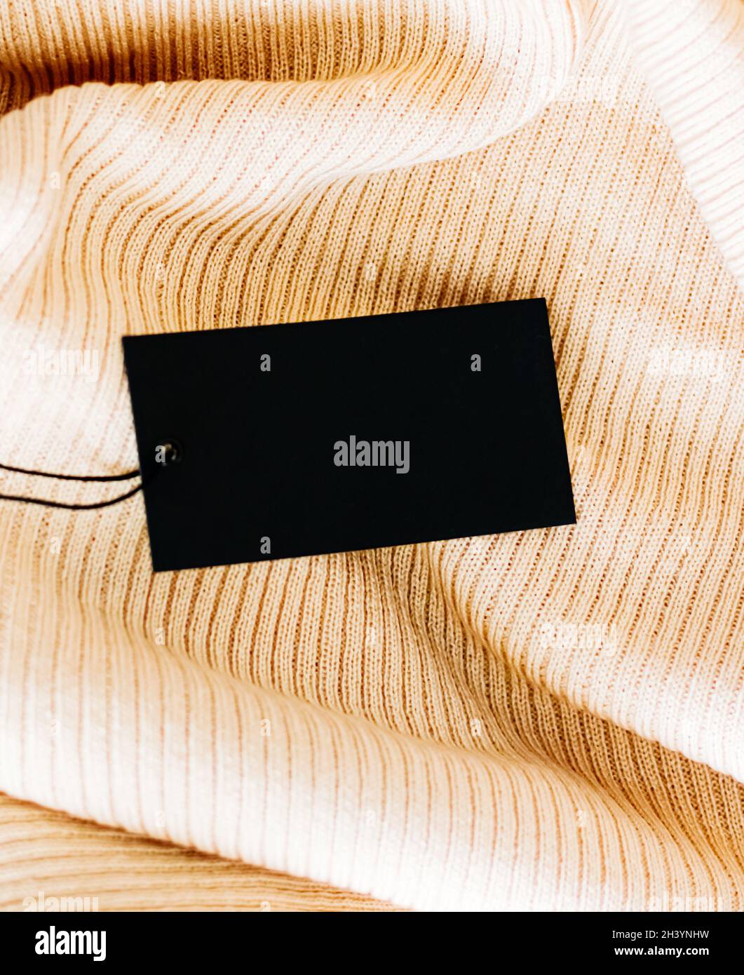 Blank black clothing tag for luxury clothing brand Stock Photo - Alamy