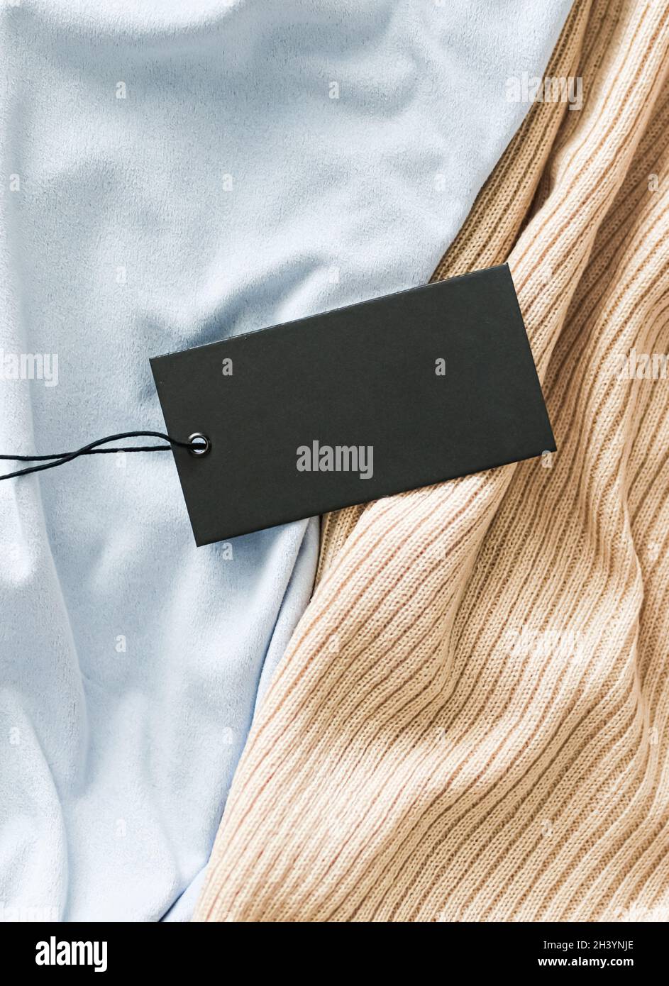 Horizontal clothing price tag on fabric background Stock Photo - Alamy