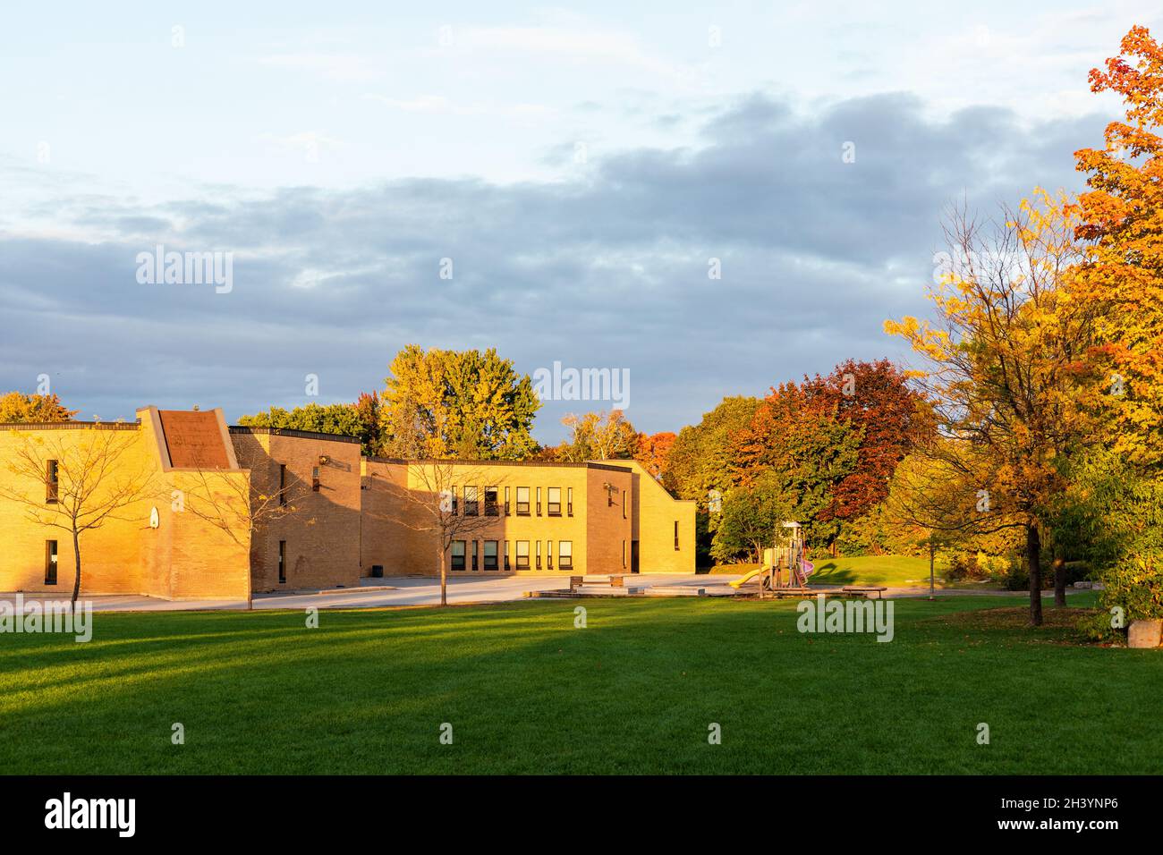 School building and yard in sunny evening in autumn. Back to school ...