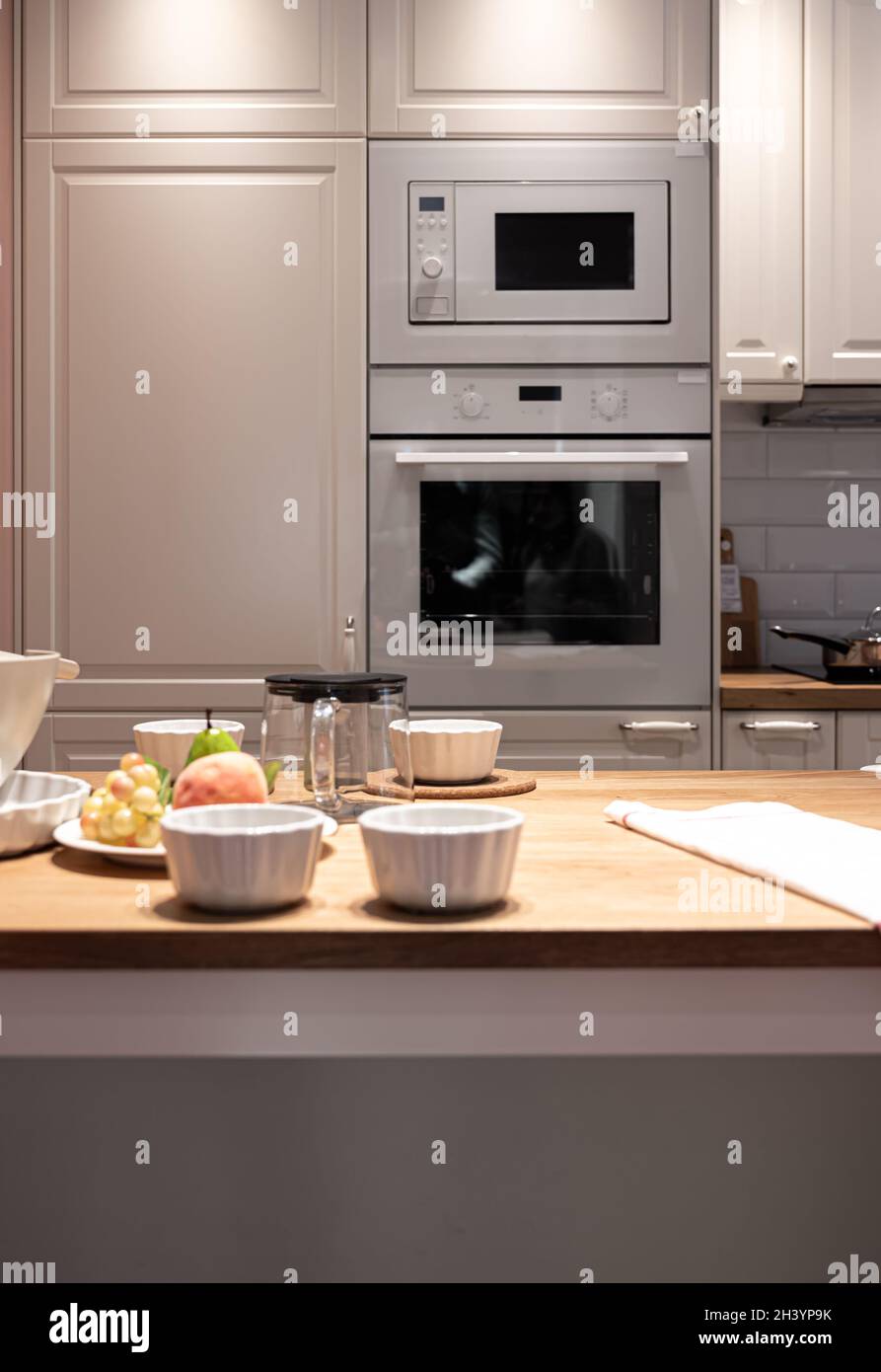 Part of the kitchen interior with utensils and fruits on the table ...