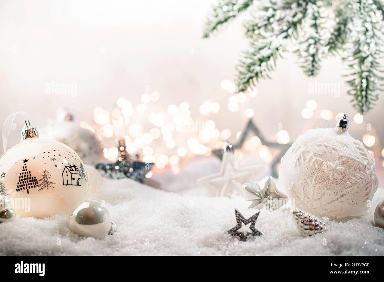 Christmas white decorations on snow with fir tree branches and ...