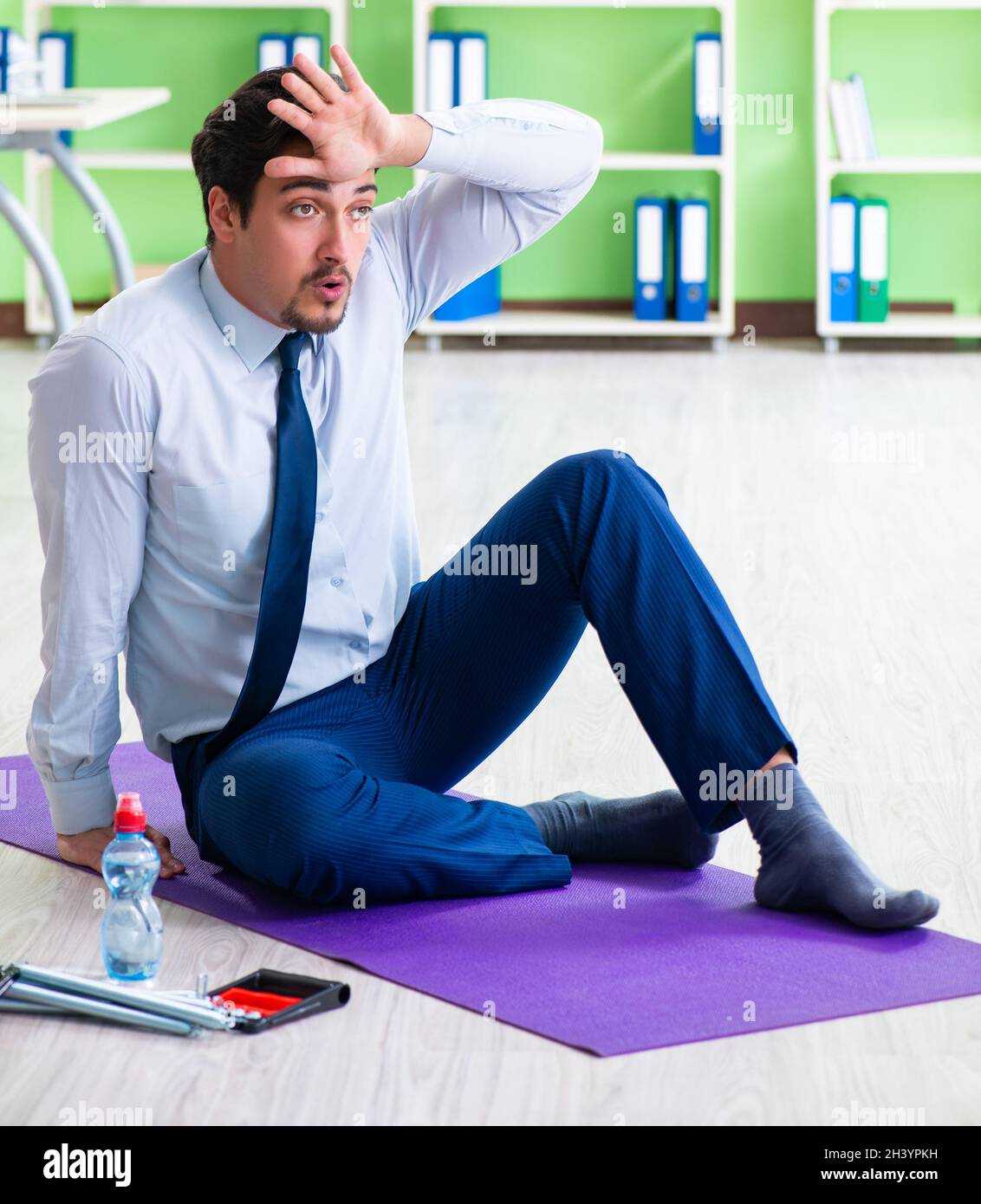 Employee doing exercises during break at work Stock Photo - Alamy
