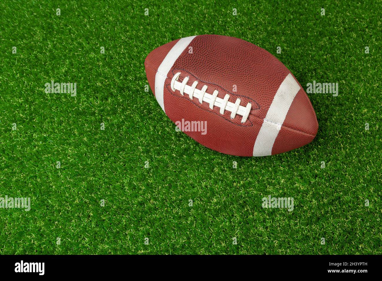 American game rugby ball on grass close up Stock Photo - Alamy