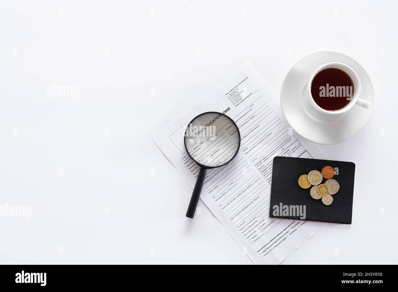 Visa application form, documents and a cup of coffee on a white ...