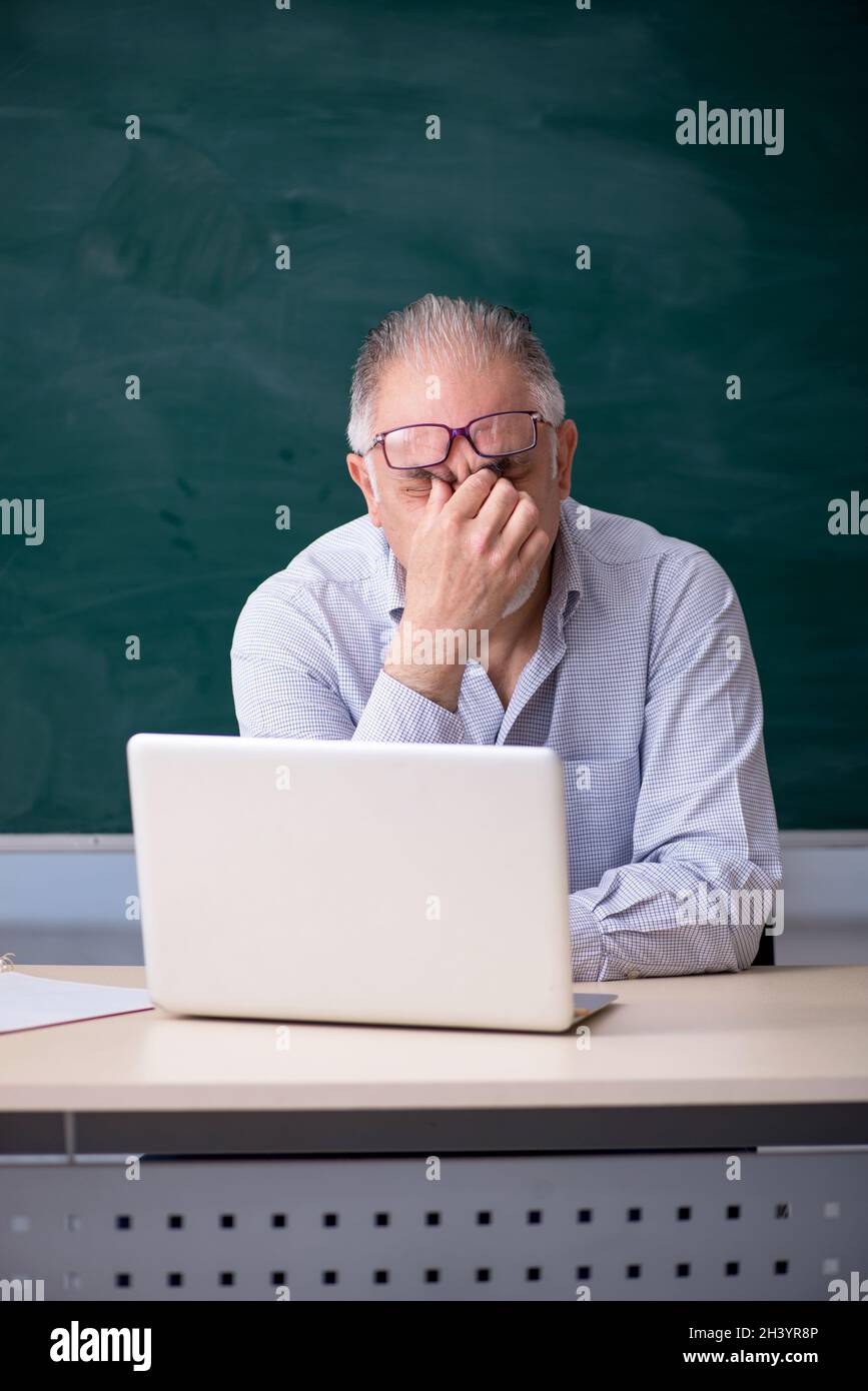 Old sad teacher hi-res stock photography and images - Alamy