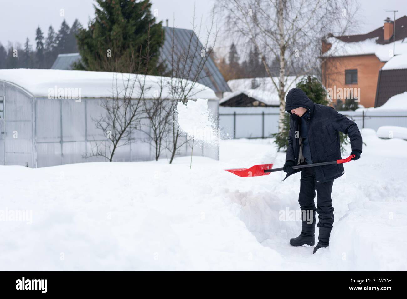 Man in black jacket shovel hi-res stock photography and images - Alamy