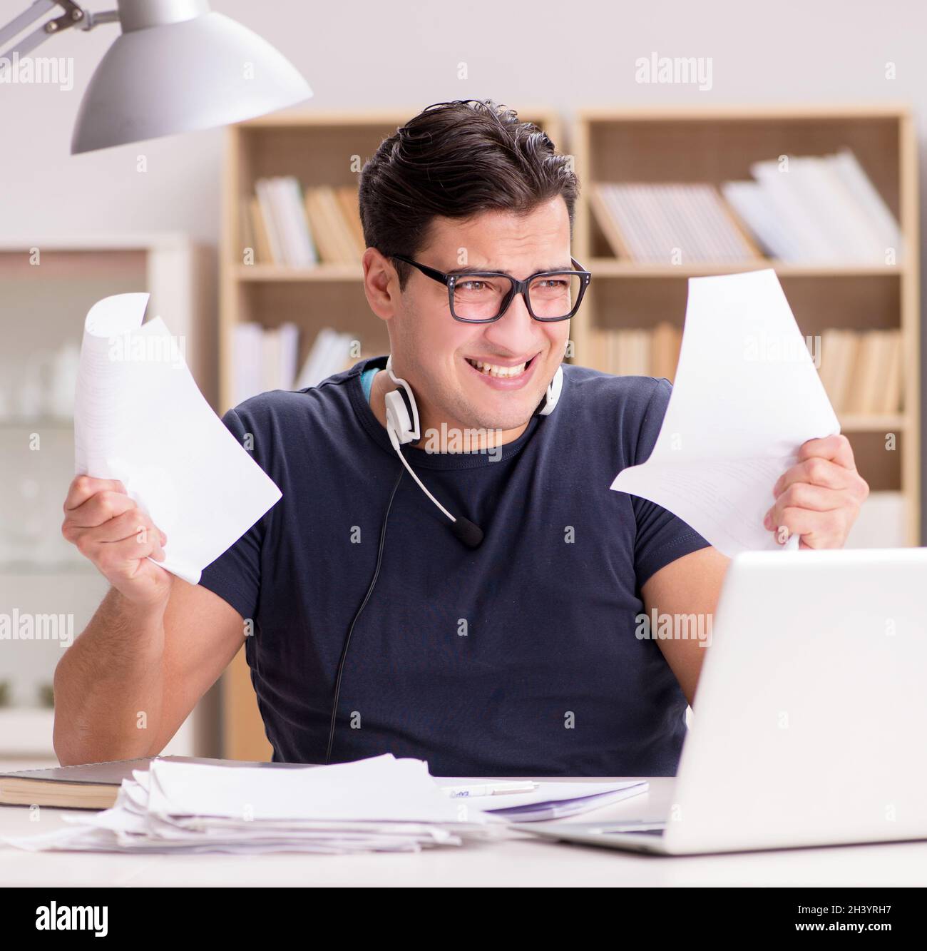 Angry man tearing apart his paperwork due to stress Stock Photo - Alamy