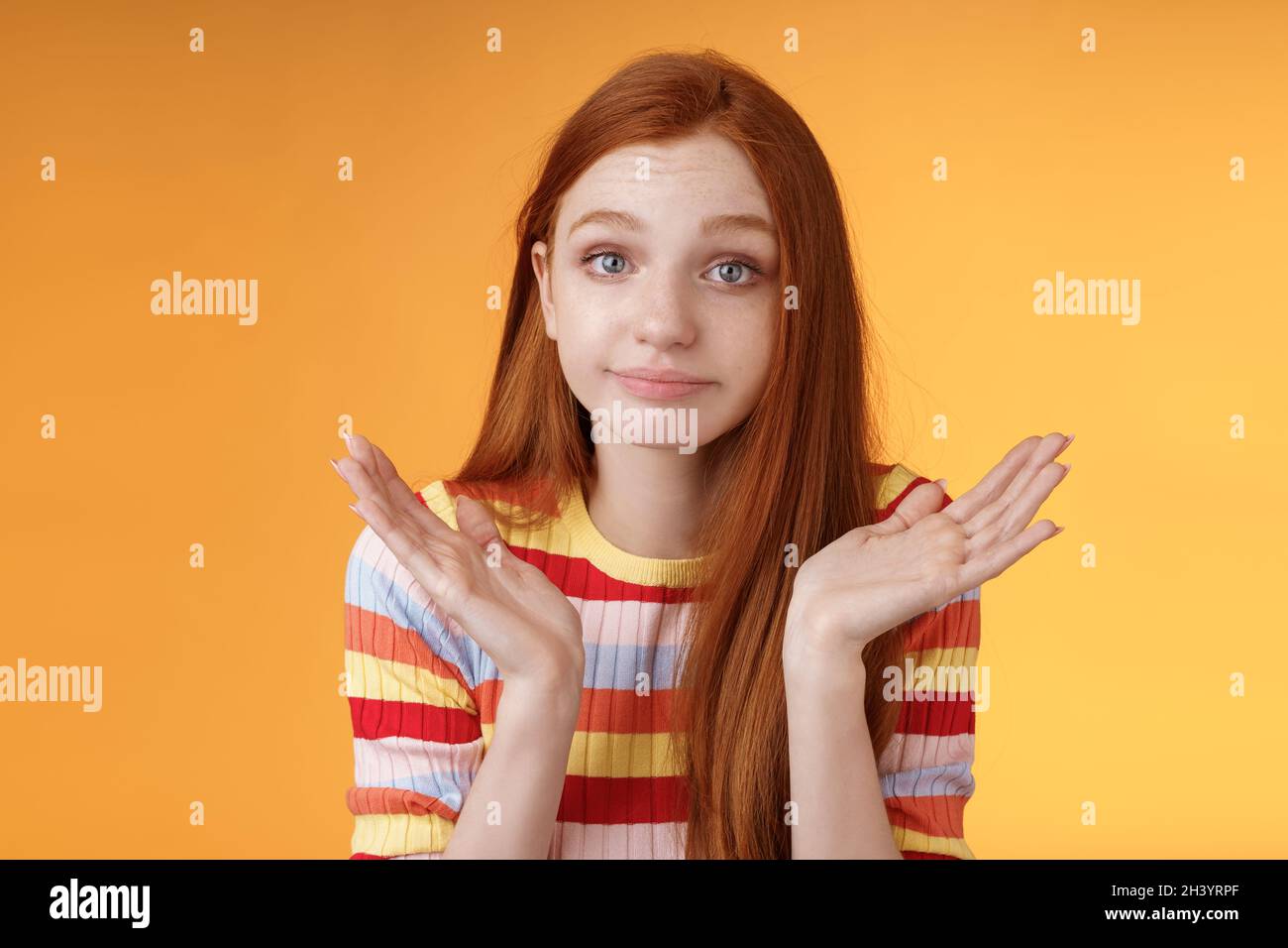 Clueless unbothered young redhead silly european girl 20s shrugging ...