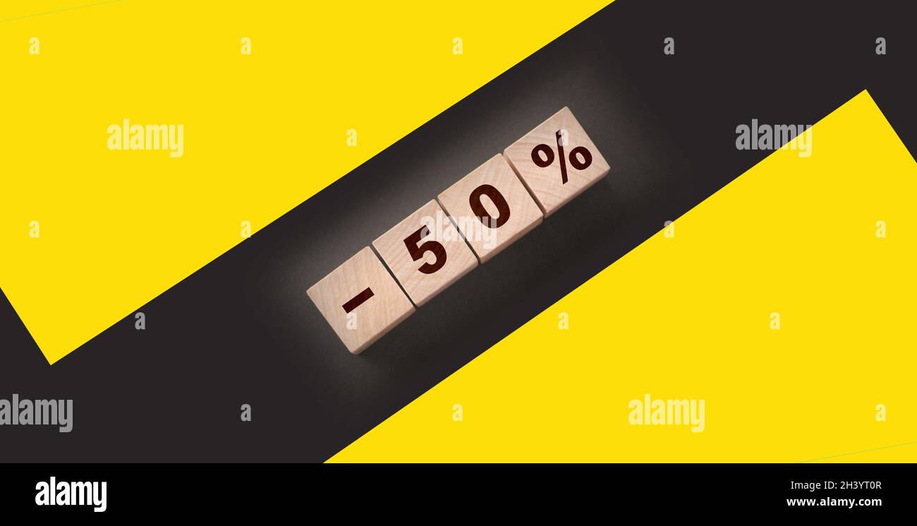 Minus 50 percent phrase on wooden blocks on black background. Sale ...