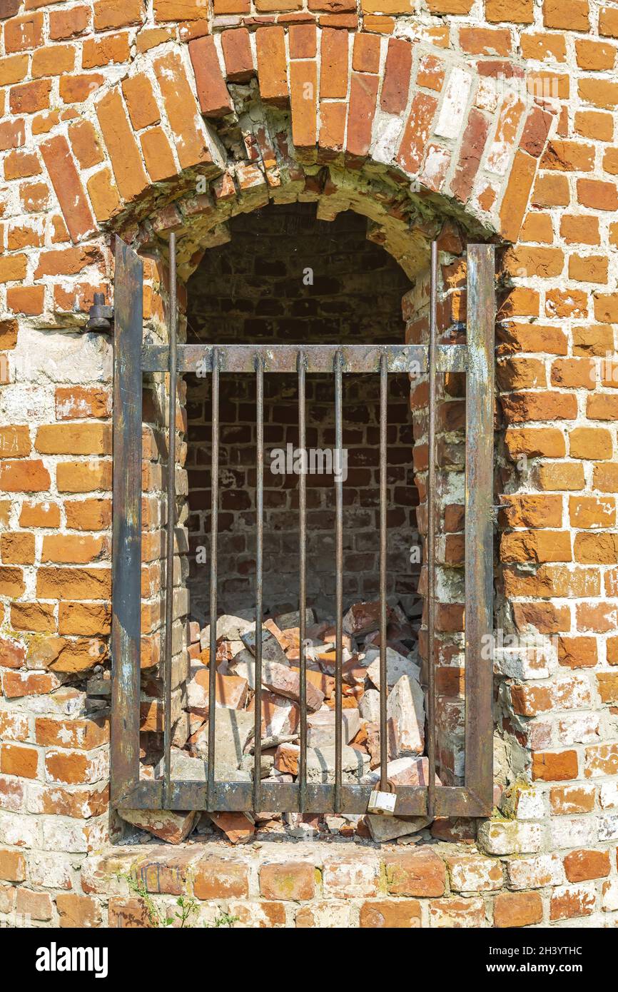 Niche in an old brick tower with a metal grate Stock Photo - Alamy