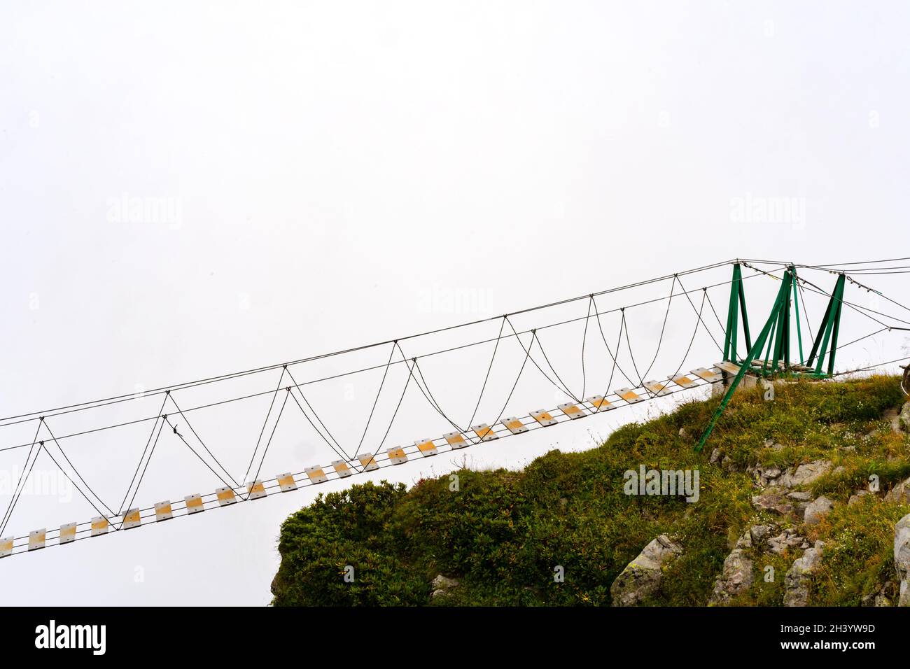 The empty rope bridge over the cliff on foggy day Stock Photo - Alamy