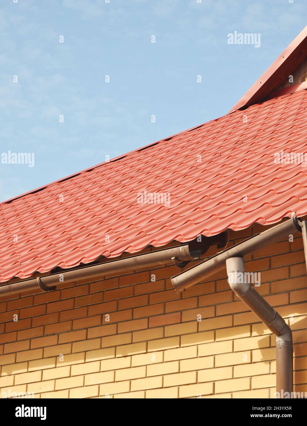 Broken rain gutters with metal roof. Ice dam. Closeup on new broken ...