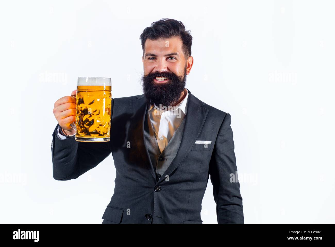 Happy man in classical suit holding glass with beer in hand. Smiling ...