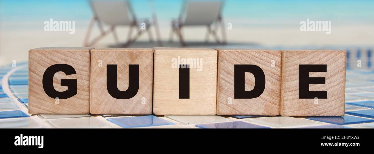 Guide Word Written In Wooden Cubes on relaxed beach landscape ...