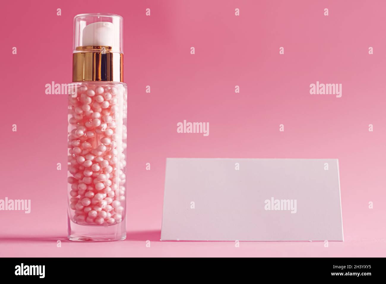 Skincare product and business card on pink background, beauty and ...