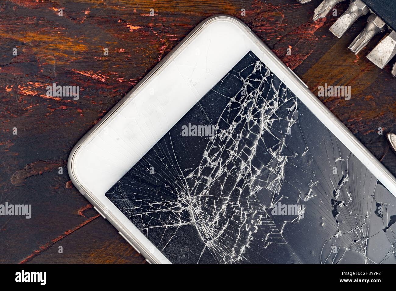 Smartphone repair concept. Damaged display of smartphone and tools ...