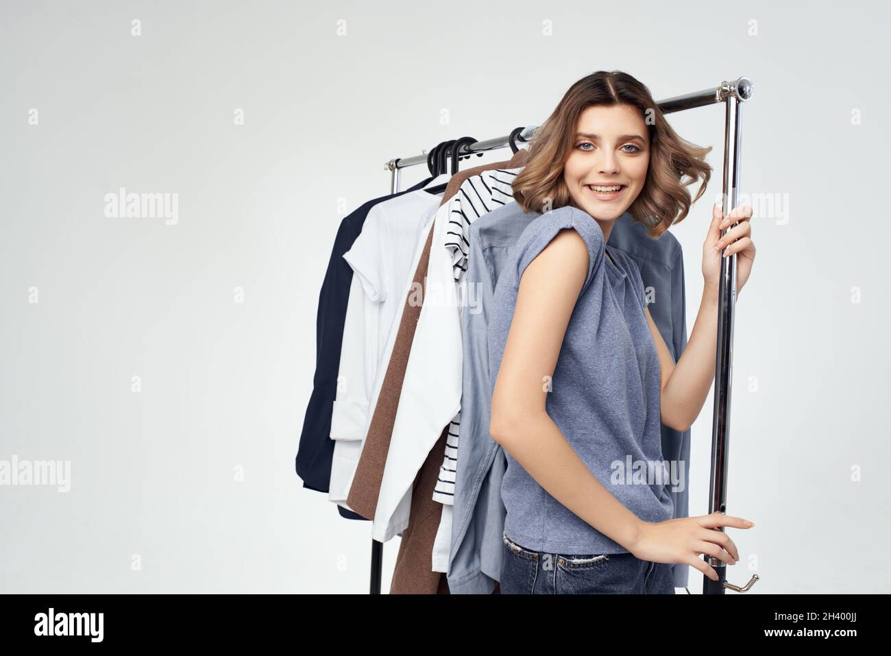 pretty woman selection of clothes near the wardrobe isolated background ...