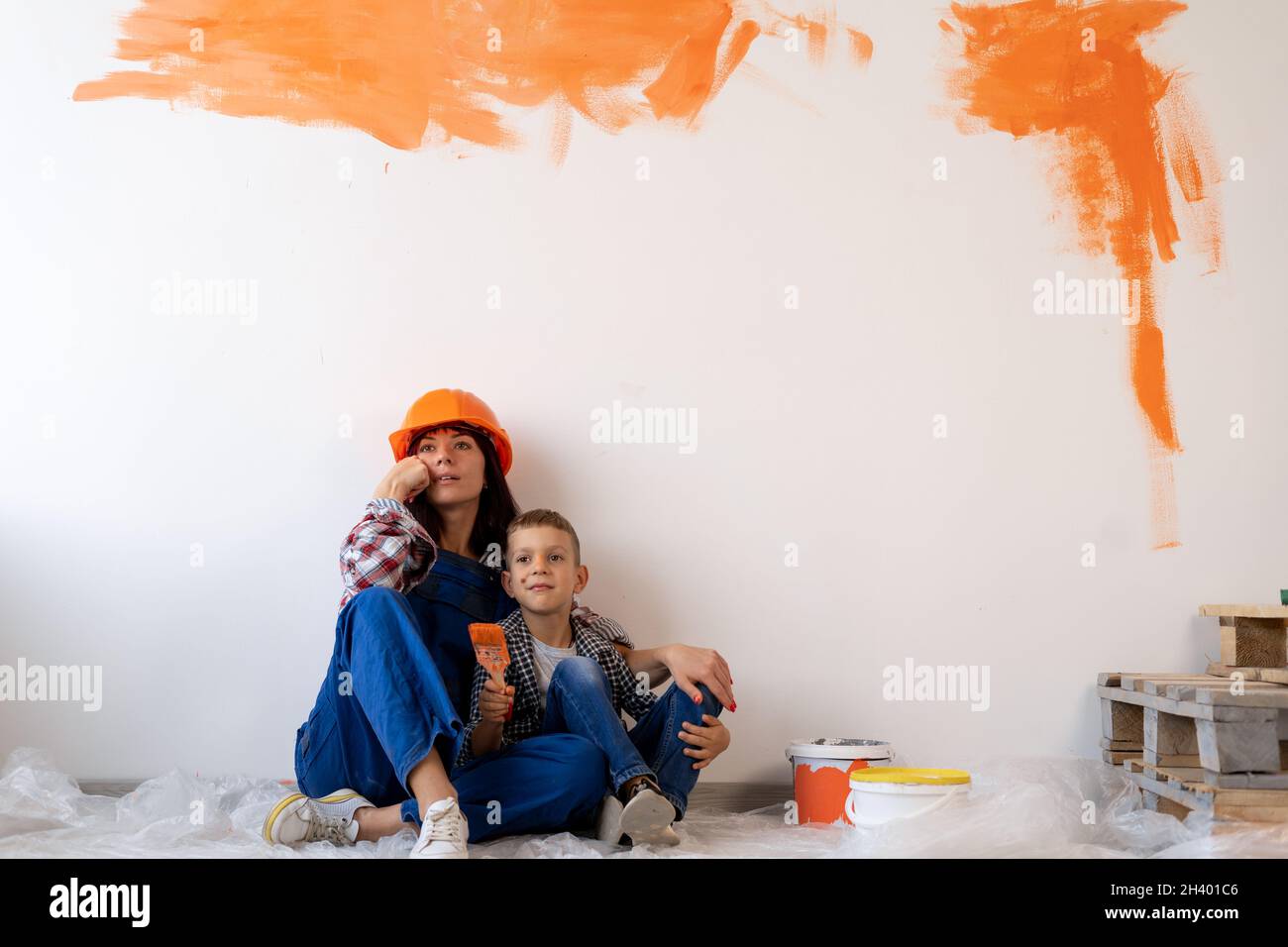 Thoughtful woman mom and son are dreaming about the project of a new ...