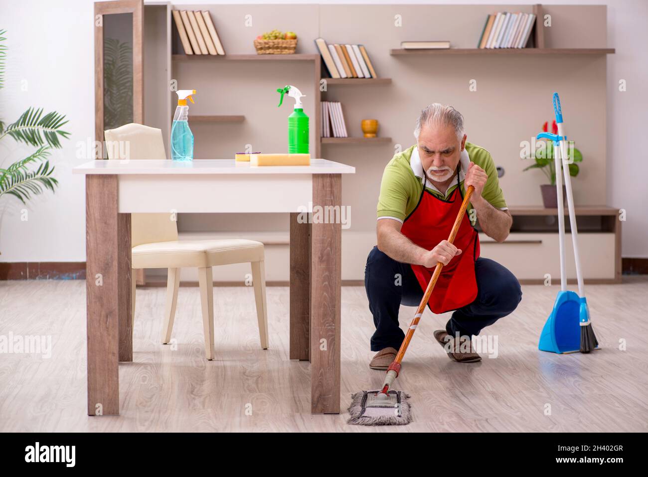 Old man cleaning the house Stock Photo - Alamy
