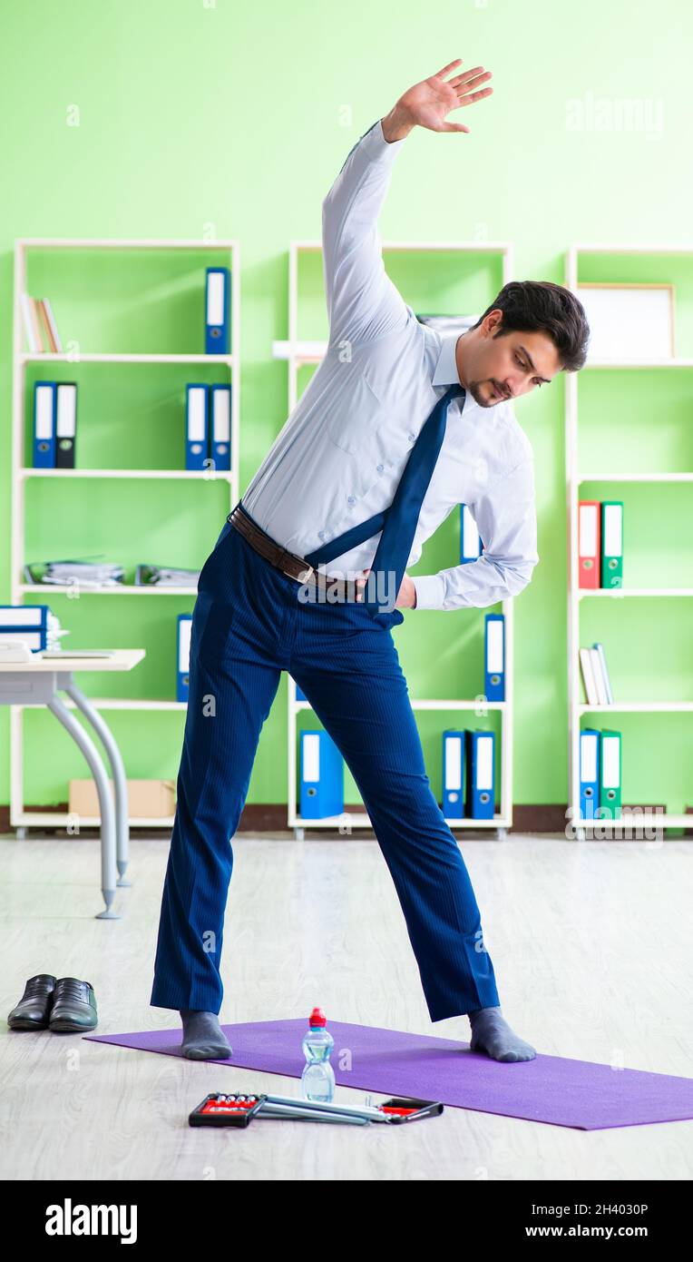 Employee doing exercises during break at work Stock Photo - Alamy