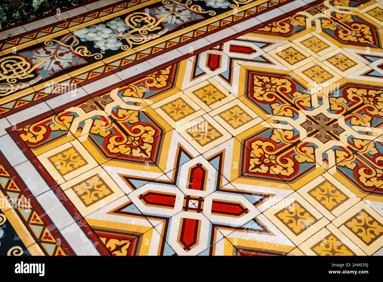 Floor tiles with arabesque ornaments in yellow, white and red colors ...