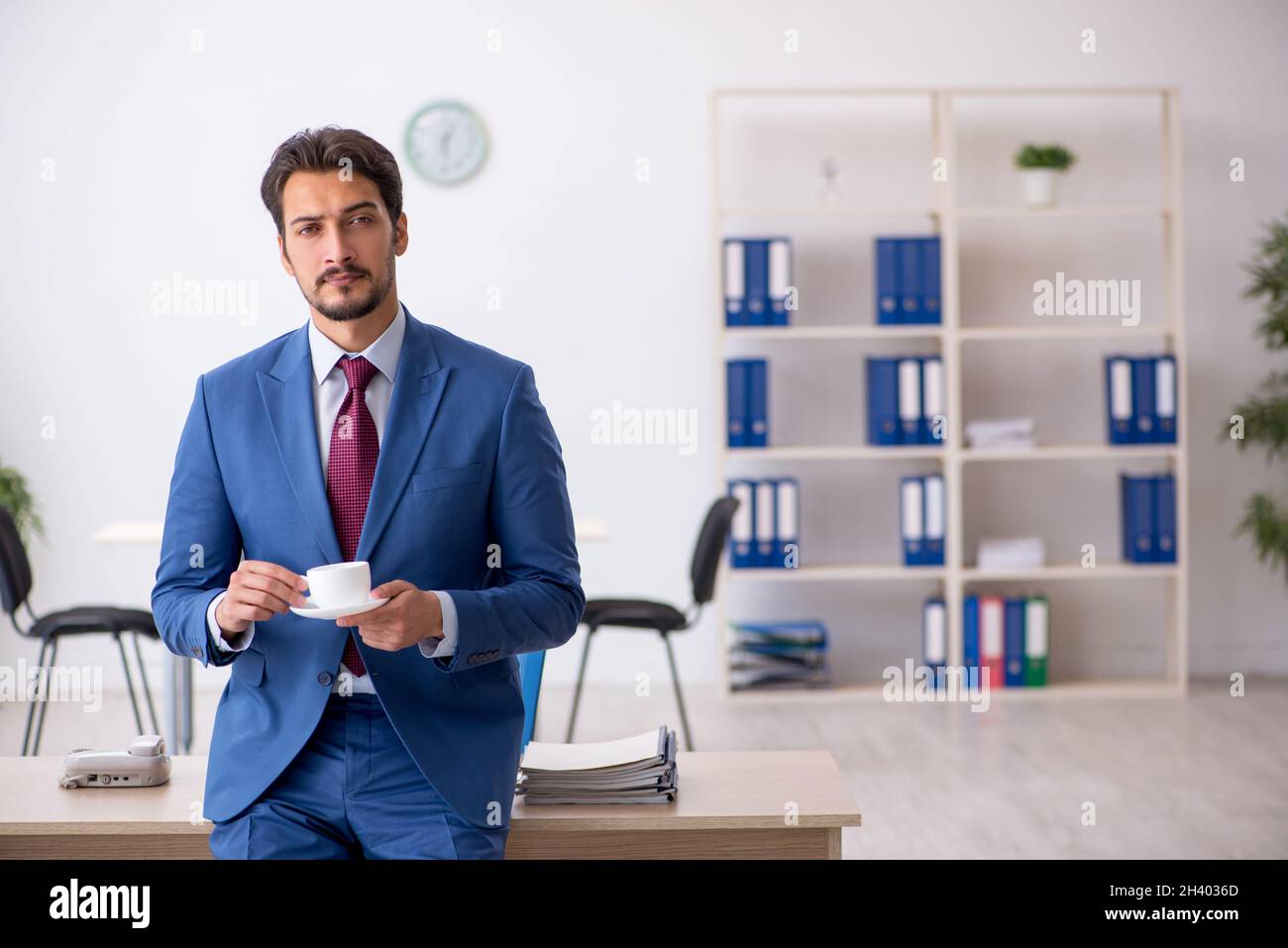 Male employee drinking coffee hi-res stock photography and images - Alamy