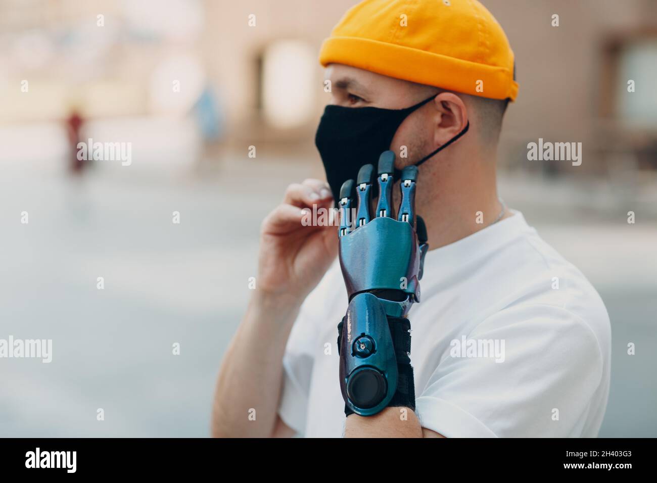 Young disabled man put on medical protective face mask with artificial ...