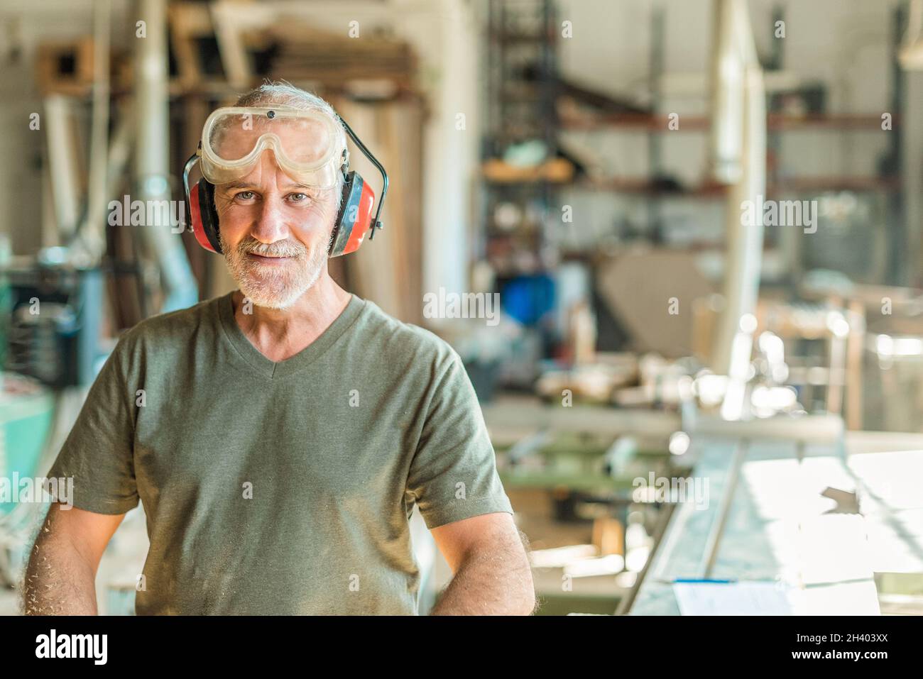 Worker smiling in the factory with the safety work equipment Stock ...