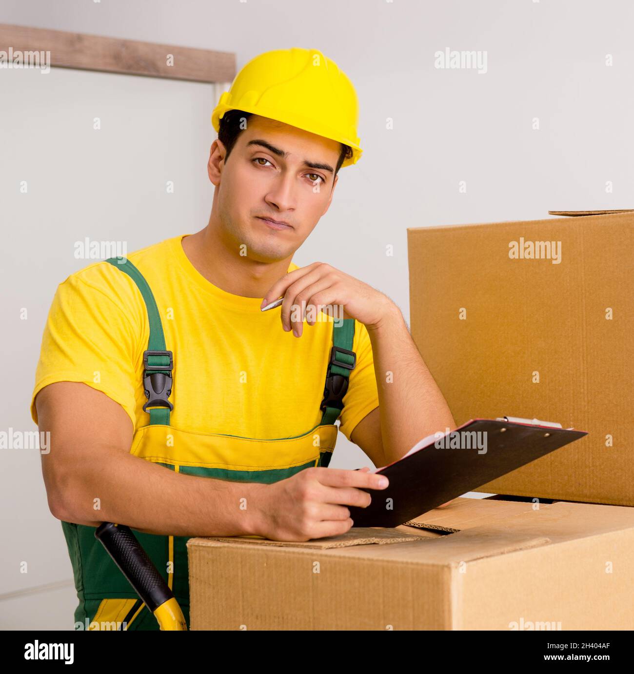 Man delivering boxes during house move Stock Photo - Alamy