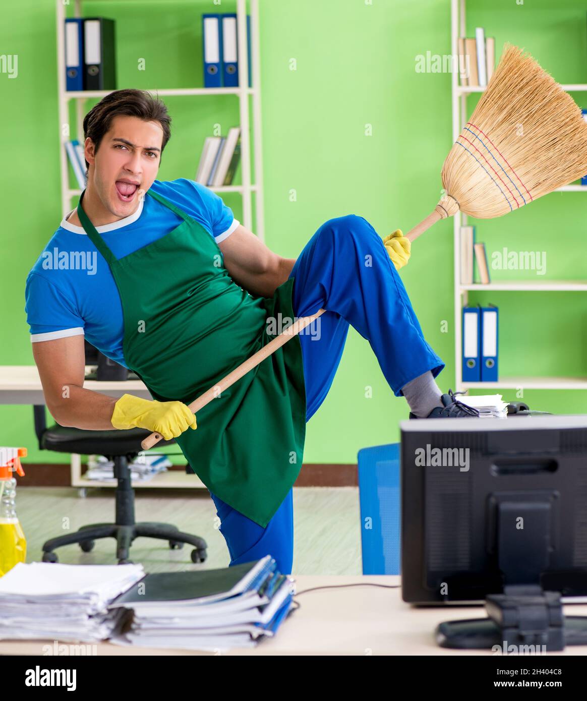 Young male handsome professional cleaner cleaning floor with bro Stock ...