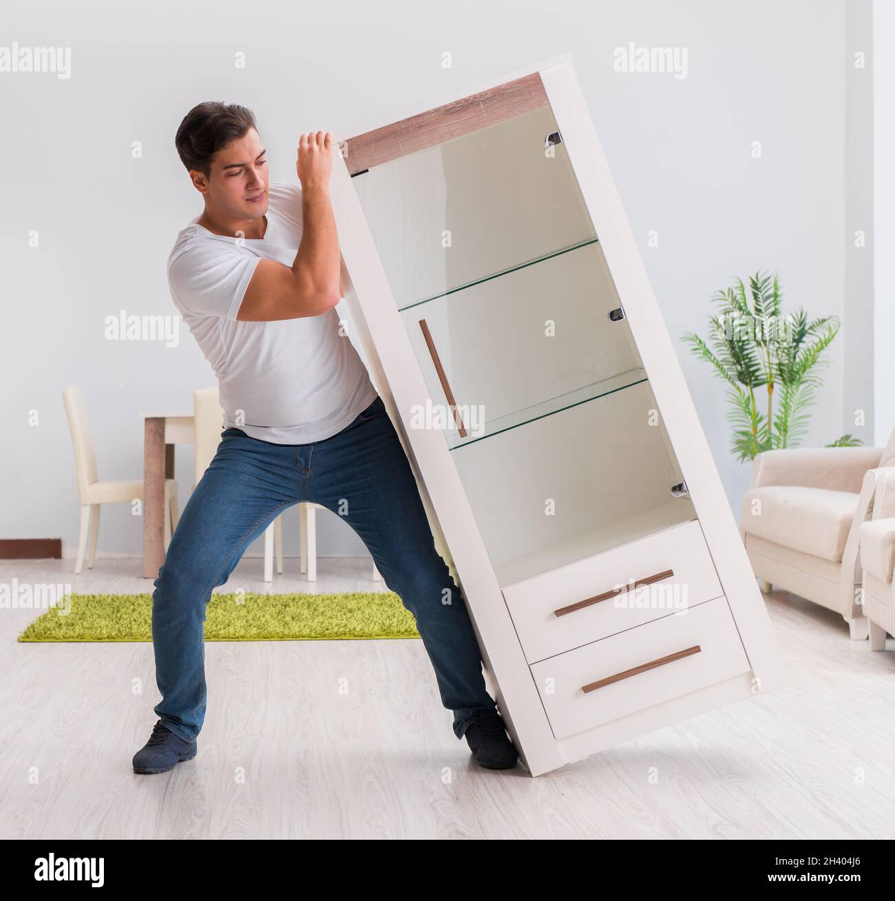 Man moving furniture at home Stock Photo - Alamy