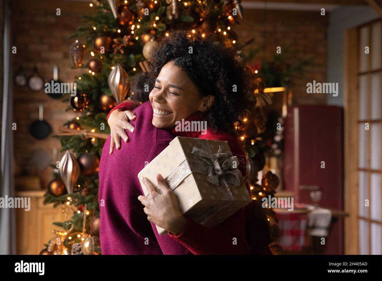Happy biracial couple exchange gifts on Christmas Stock Photo - Alamy