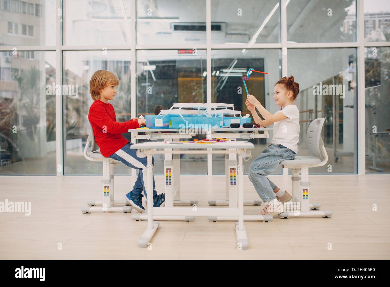 Smiling kids boy and girl child constructor checking technical toy ...