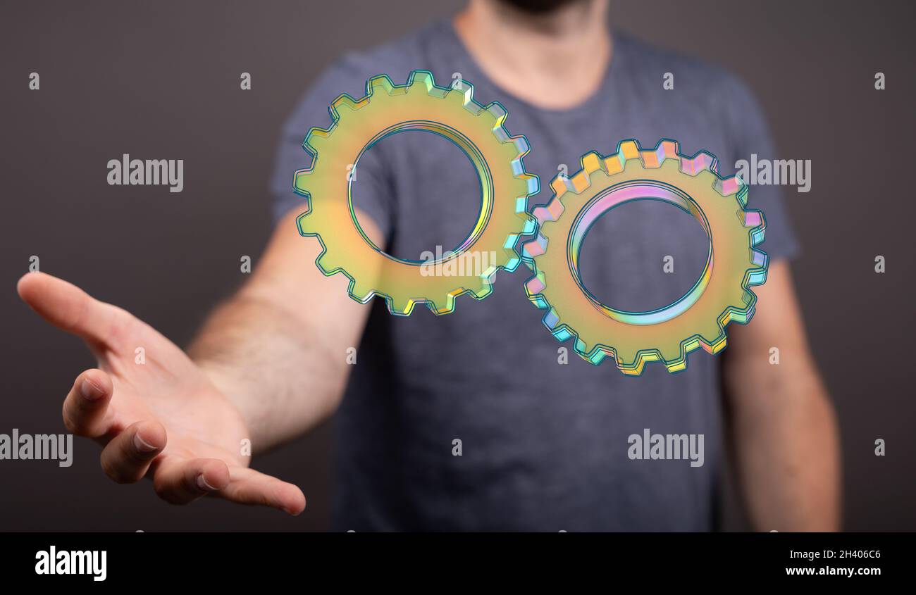 A person presenting a 3D rendering digital gears for business success ...