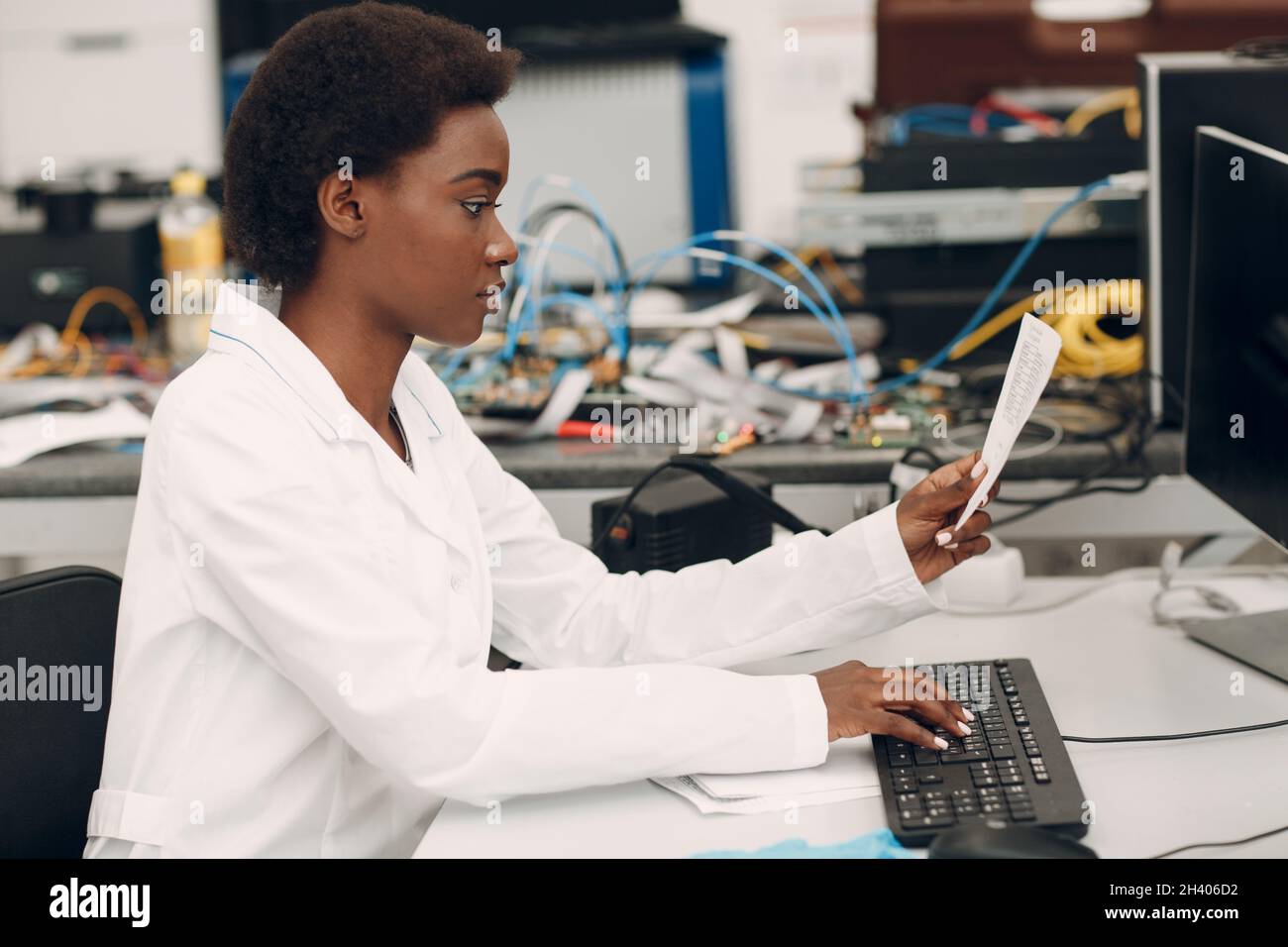 Scientist african american woman working in laboratory with electronic ...