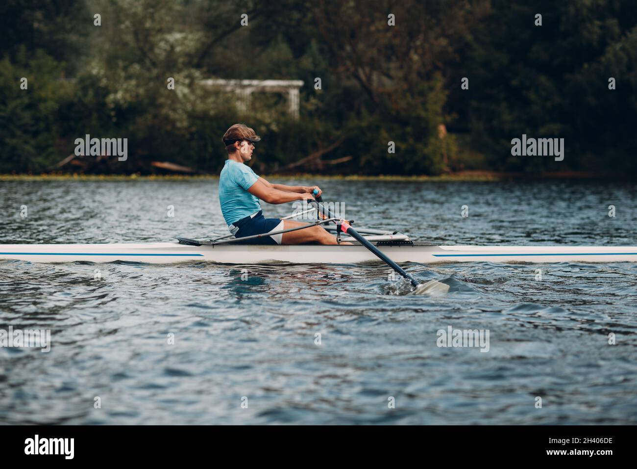 Sportsman single scull man rower rowing on boat Stock Photo - Alamy