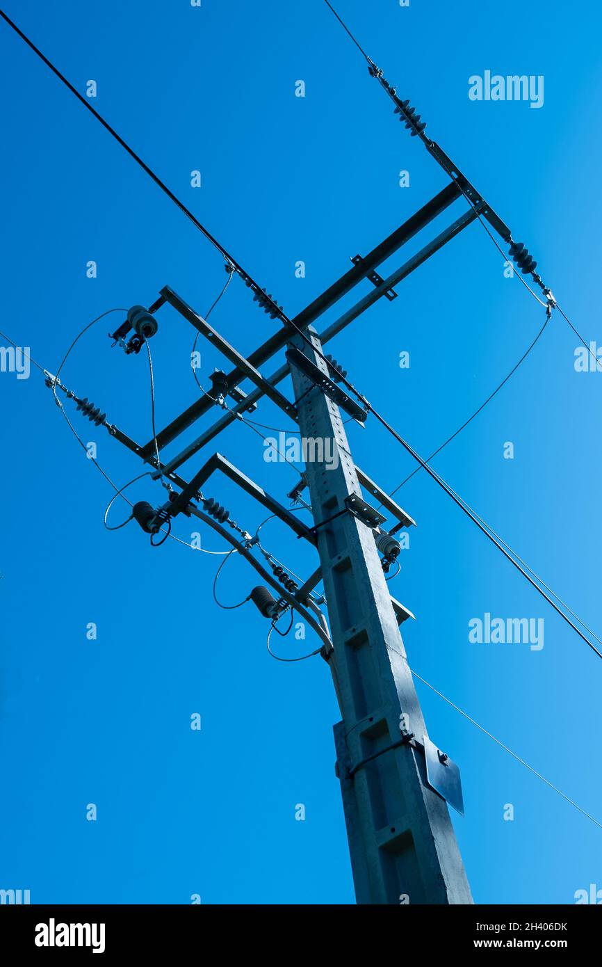 A vertical shot of an electric power distribution turret on a blue sky ...