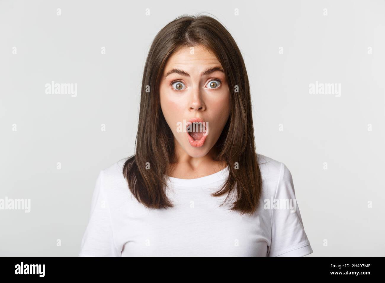 Close-up of impressed girl drop jaw amazed, white background Stock ...