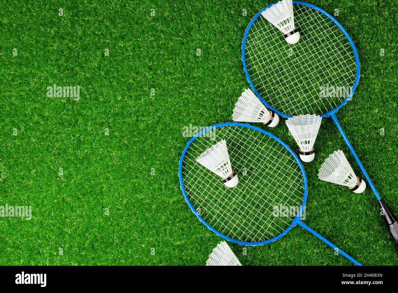 Badminton game rackets and shuttlecock on grass Stock Photo - Alamy