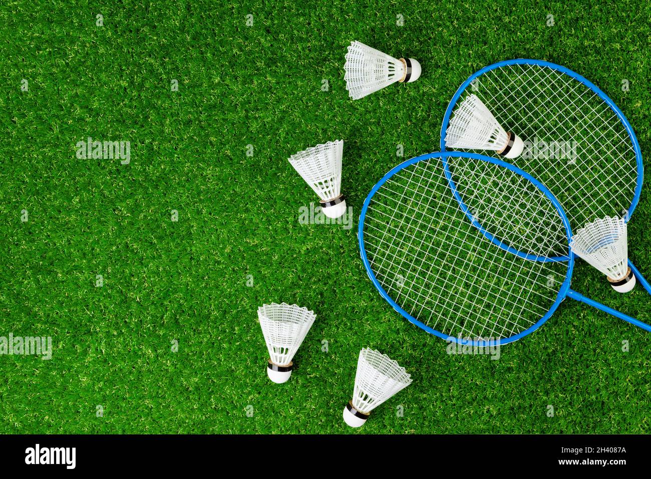Badminton game rackets and shuttlecock on grass Stock Photo - Alamy