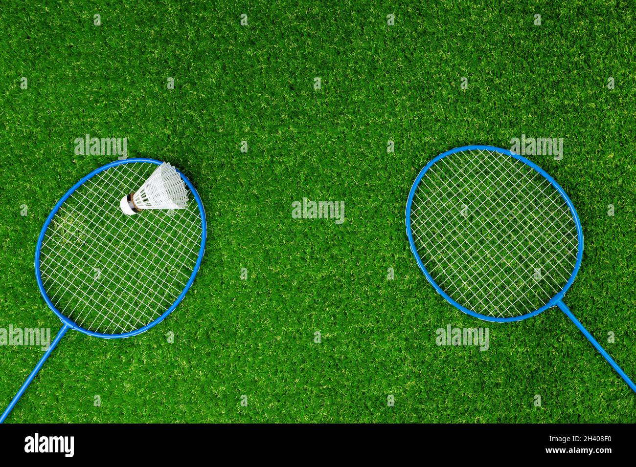 Badminton game rackets and shuttlecock on grass Stock Photo - Alamy