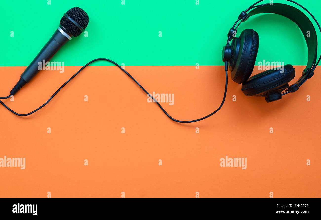 Microphone and headphone on a orange and green background Stock Photo ...