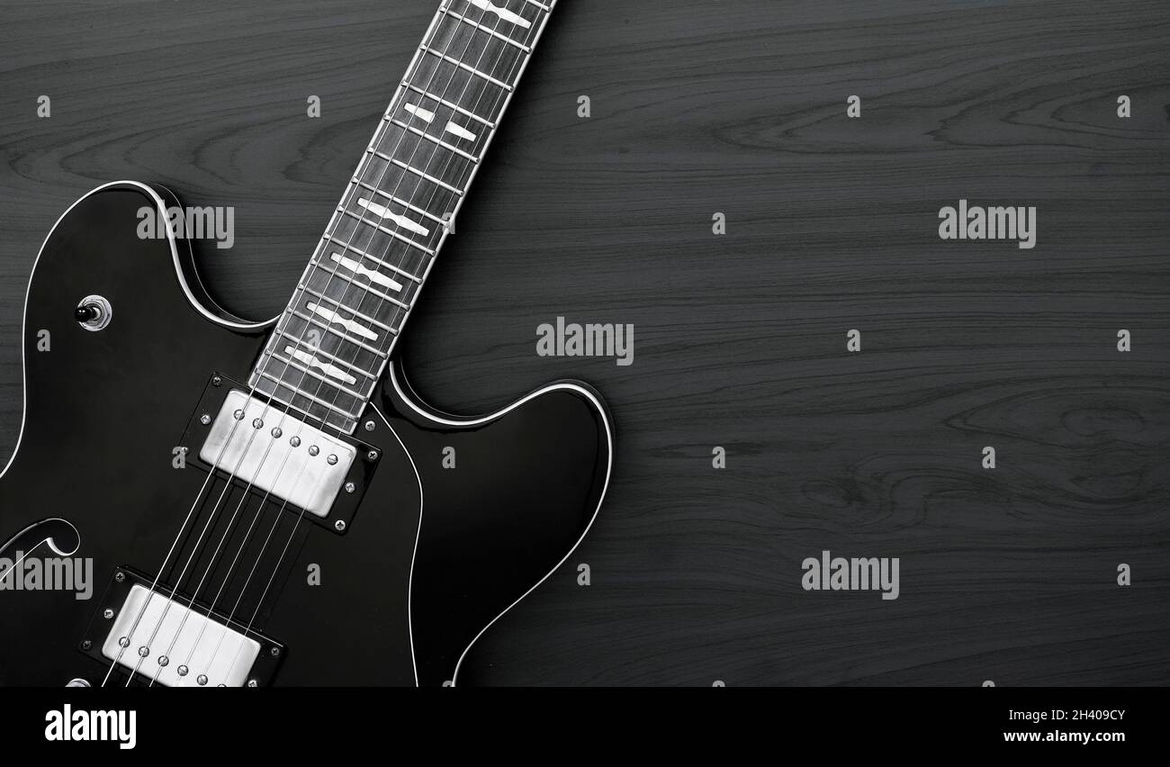 Electric guitar on a dark wood background Stock Photo - Alamy