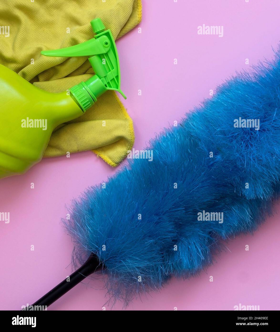 Duster and spray bottle on a pink background Stock Photo - Alamy