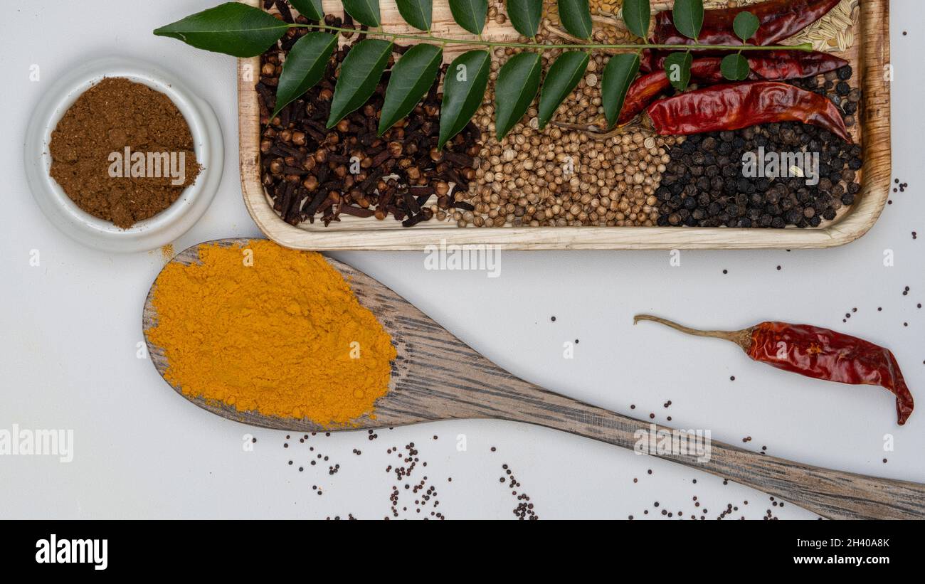 Turmeric powder and ingredients to make curry powder in palm leaf plate ...