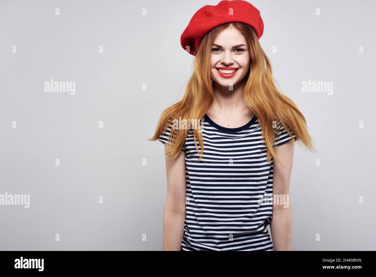 pretty woman in a striped t-shirt red lips gesture with his hands ...